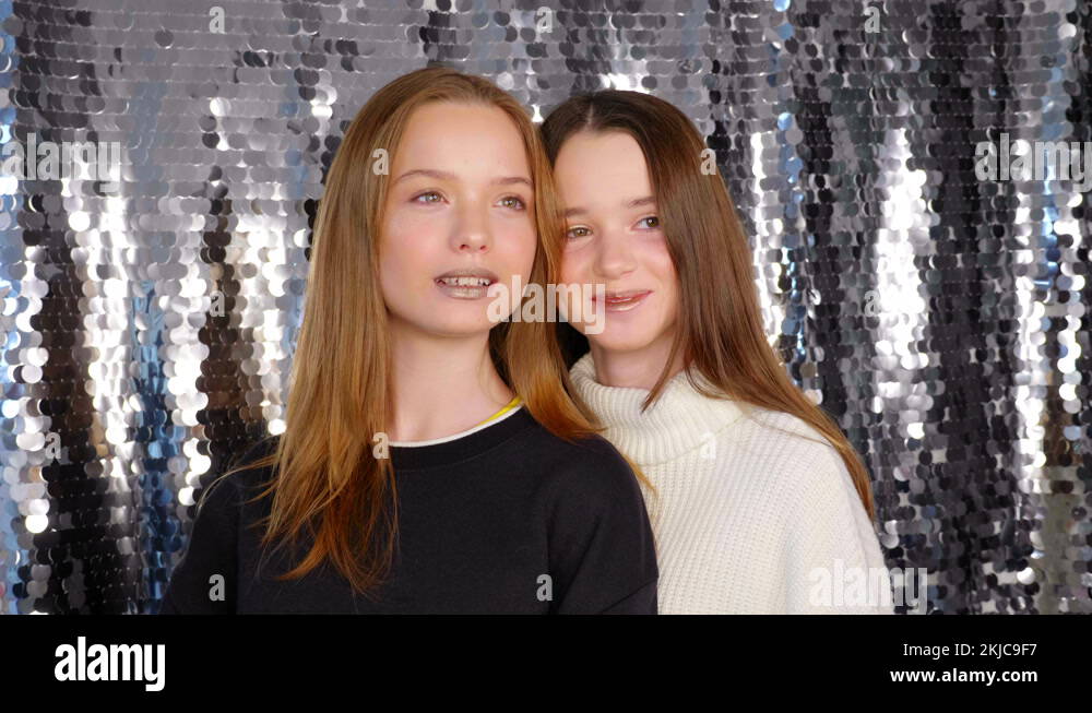 Two girl with beautiful makeup laugh and pose for a photographer in ...