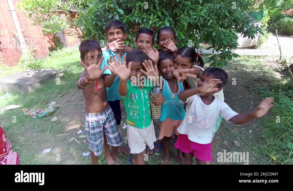 Little poor orphan children waving goodbye to the camera, poverty and ...