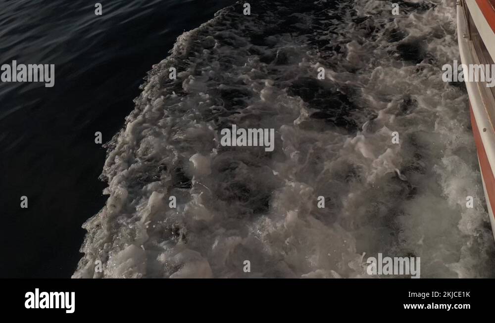 Shot of bow waves (waves set up at the bows of a moving ship) as the ...