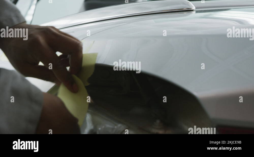 African American male car mechanic taping a body of a car Stock Video ...