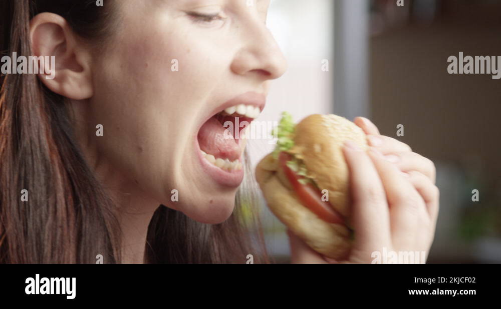 Young woman eating cheeseburger model Stock Videos & Footage - HD and ...