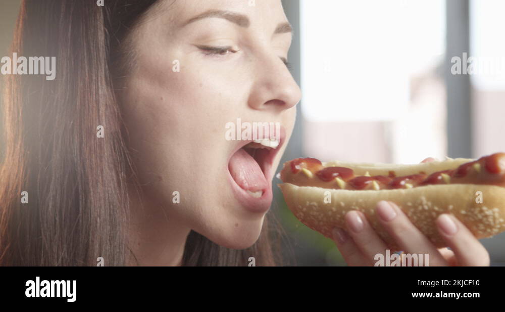 Woman eating hot dog Stock Videos & Footage - HD and 4K Video Clips - Alamy