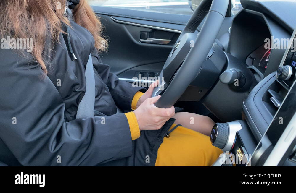Woman driver driving her car, female hands on the steering wheel of ...