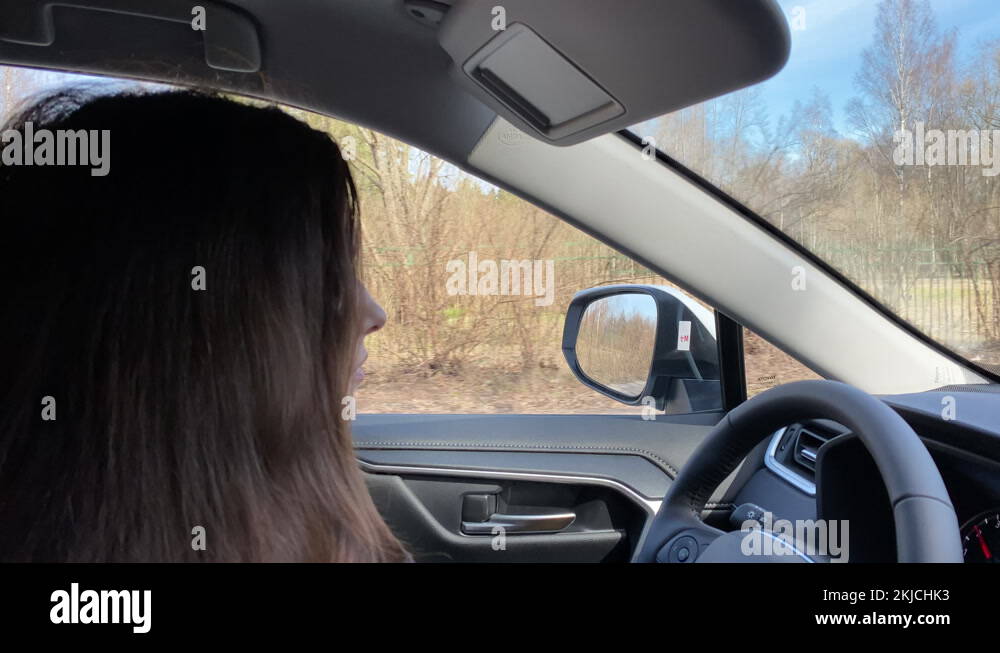 Female driver driving her car, woman behind the wheel Toyota RAV4 ...