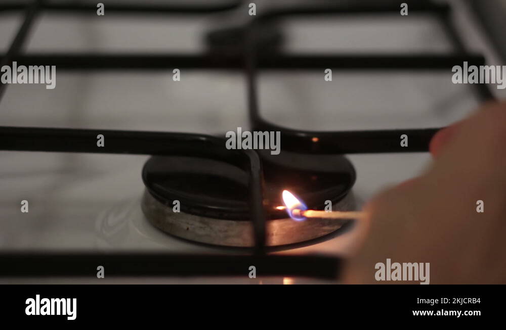 A burning gas burner. The kitchen gas burner burns in blue. A gas ...