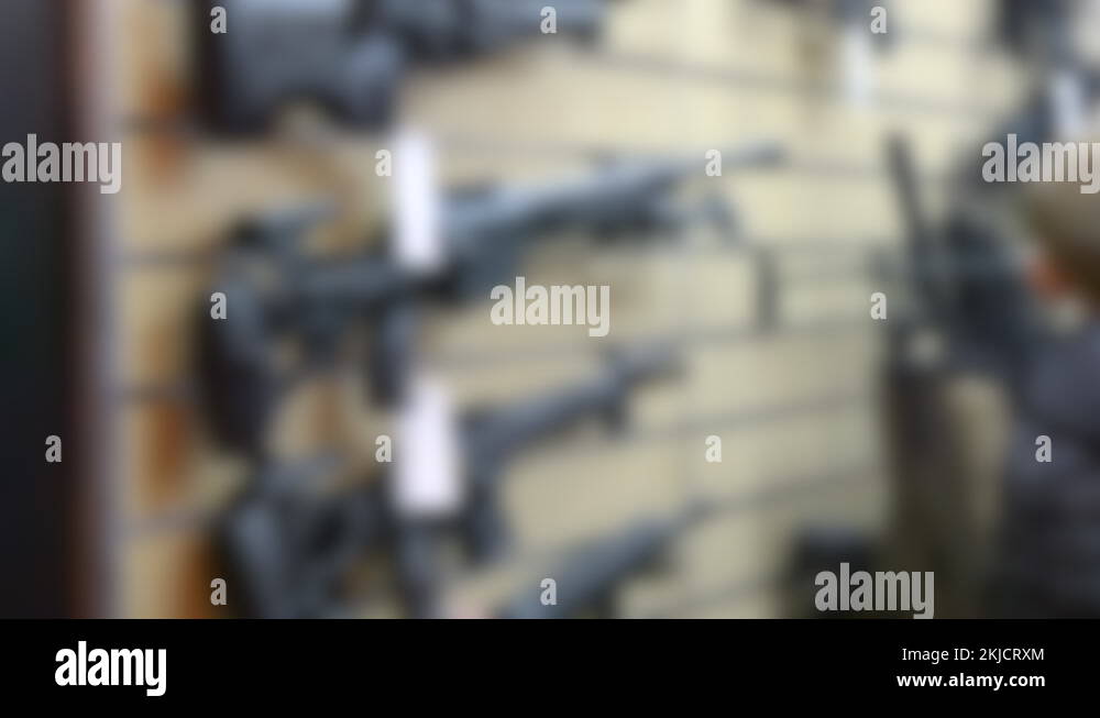 Blurred background. Kalashnikov assault rifles of various modifications ...