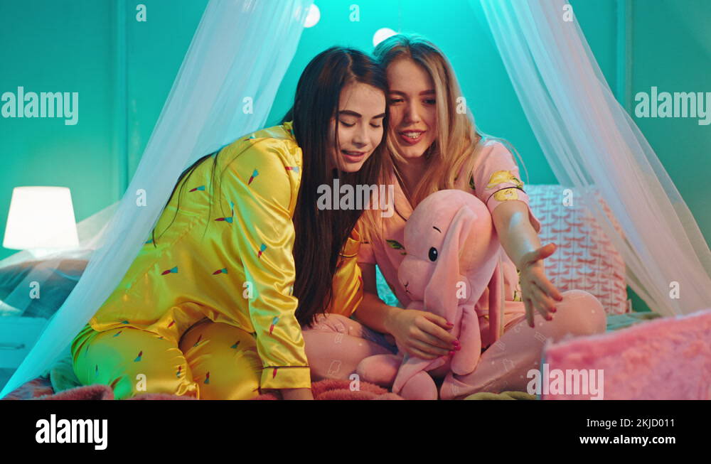 Charismatic two friends pretty young women have a sleepover time ...
