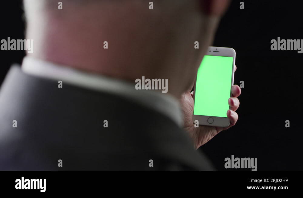 Elegant Man in a suit Using a Smart Phone with Green Screen on the ...