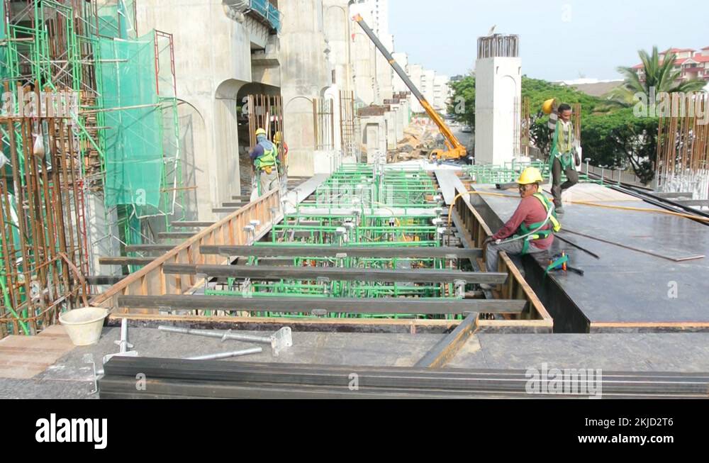 Construction workers installing & fabricating timber formworks and ...