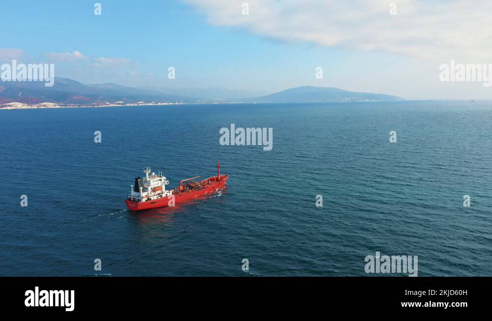 Aerial footage of ultra large cargo ship at sea, top down drone view ...