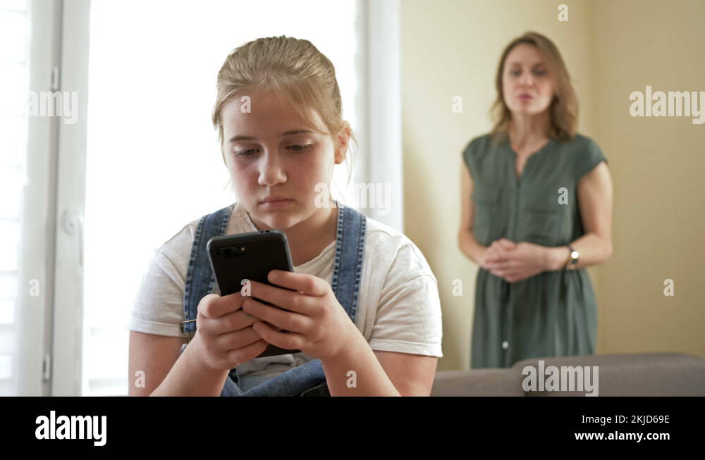 Mom Is Outraged That She Reads A Teenage Daughter On A Mobile Phone Girl Hides Stock Video