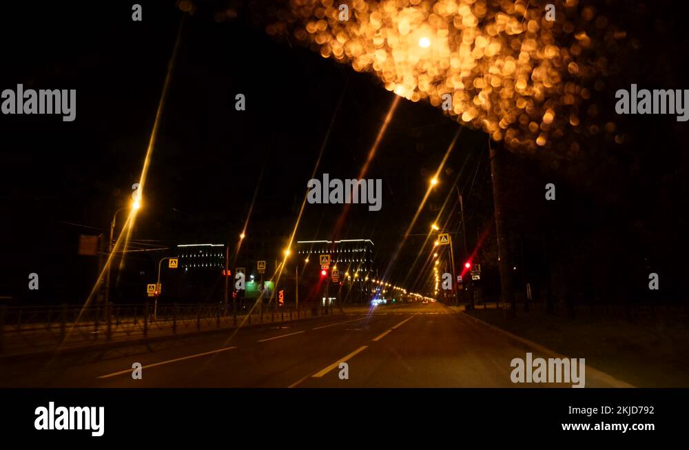4k. night drive on empty city street road from the window of speed car ...