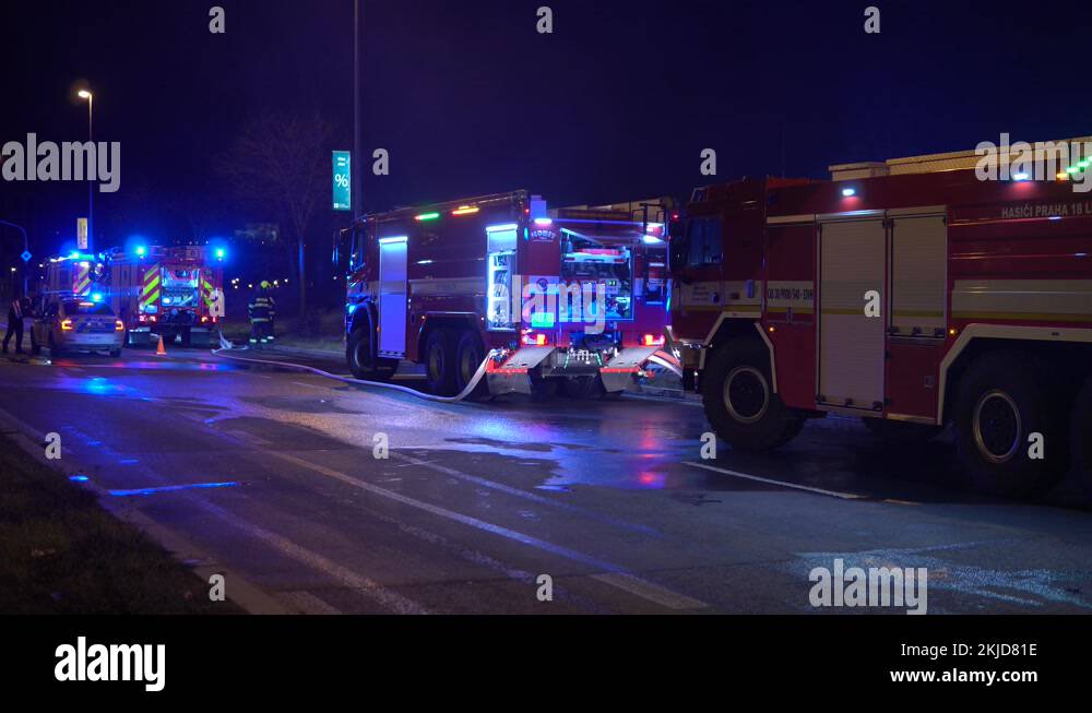 Police and firefighters with fire trucks and a police car on a scene in ...
