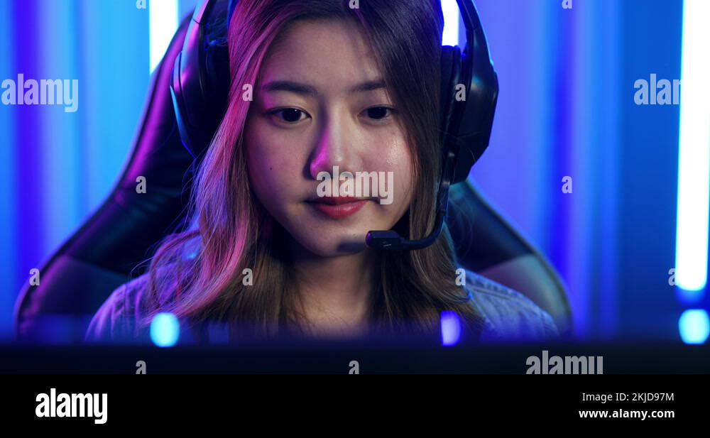 Young Asian woman gamer having live stream and playing in online game ...