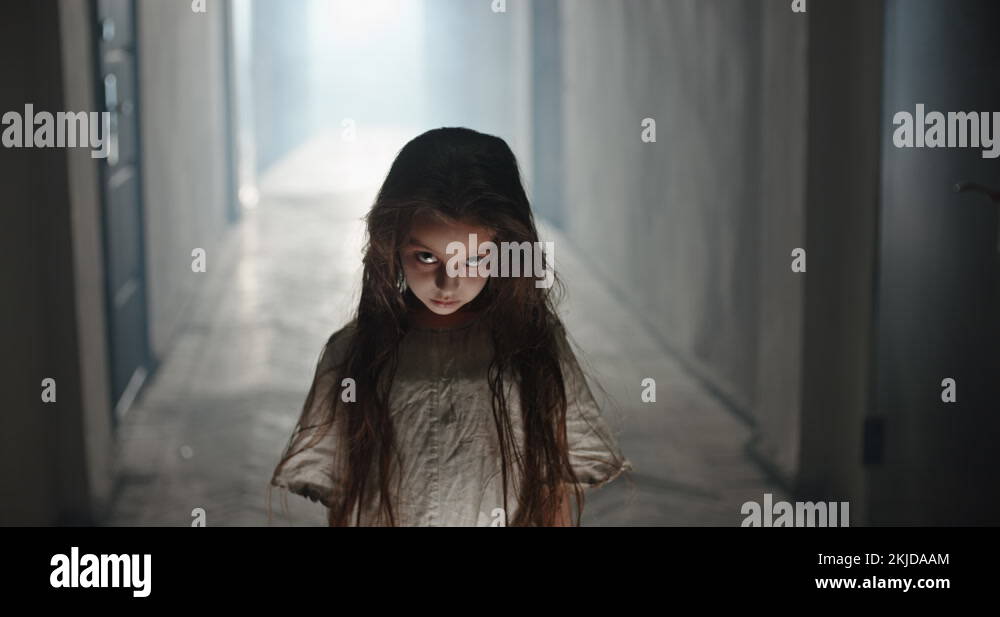 Demonic psycho child in cursed house. Little girl, dressed in halloween ...
