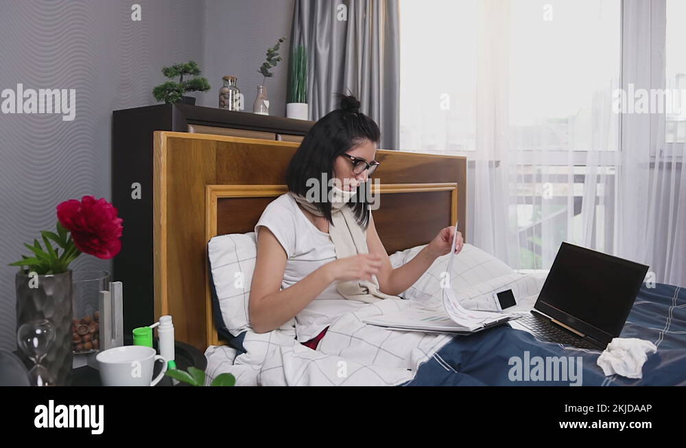 Unhappy exhausted sick young woman working distantly at home during ...