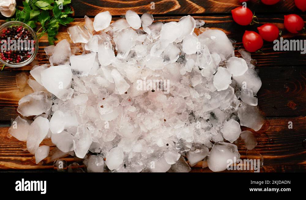 Chef hands puts fresh T-Bone steak on ice. Raw meat steak with ice ...