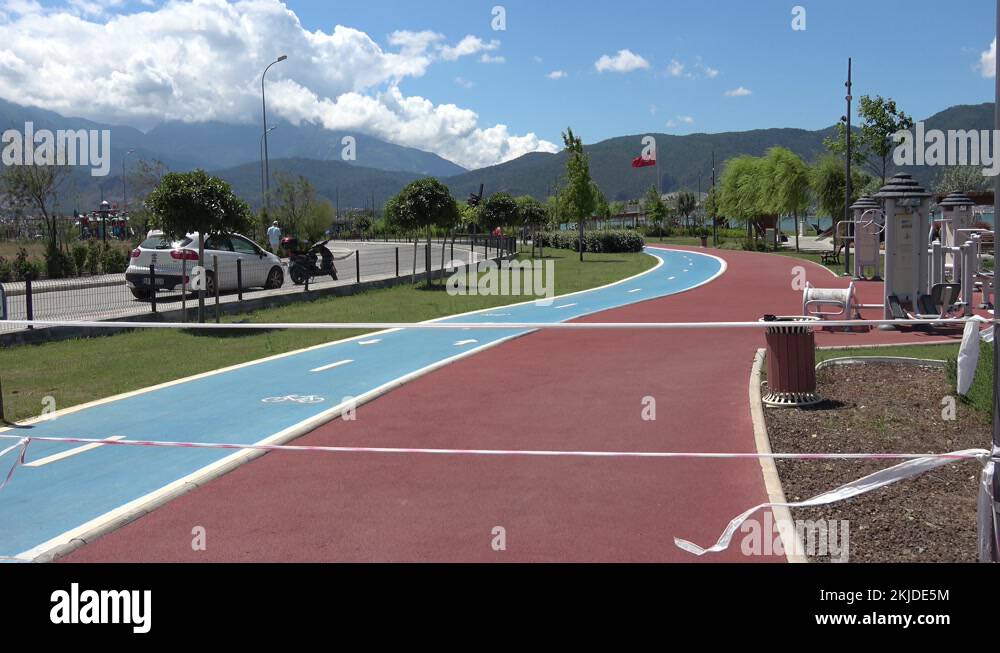 Cycle path shut with tape and people on bicycles driving along the road ...