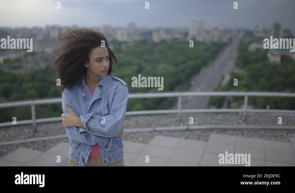 Depressed young woman walking on rooftop, crisis of puberty age ...