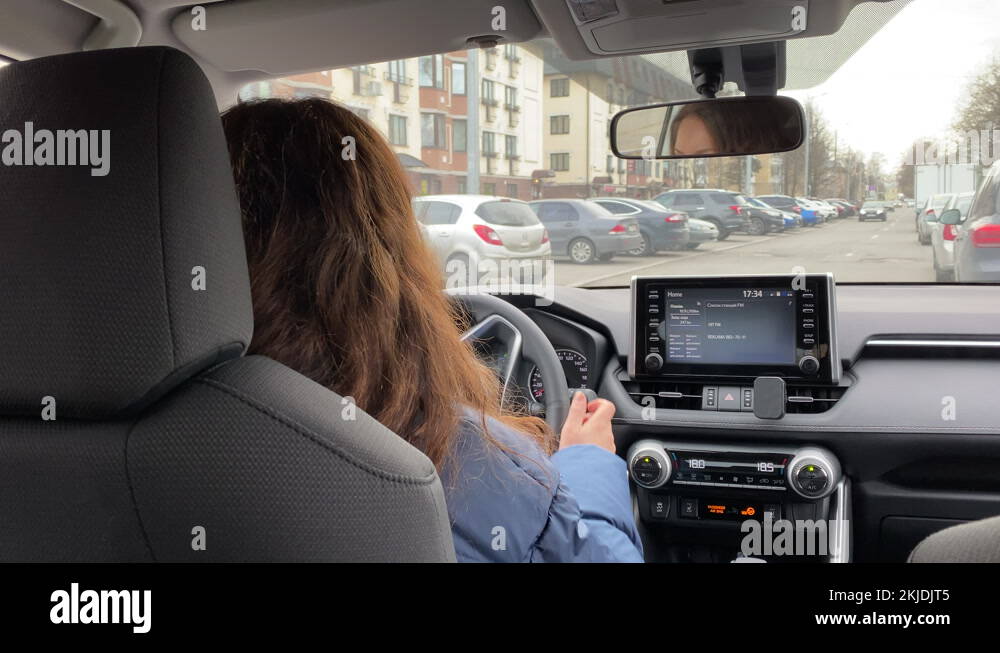 Female driver driving her car, woman behind the wheel Toyota RAV4 ...