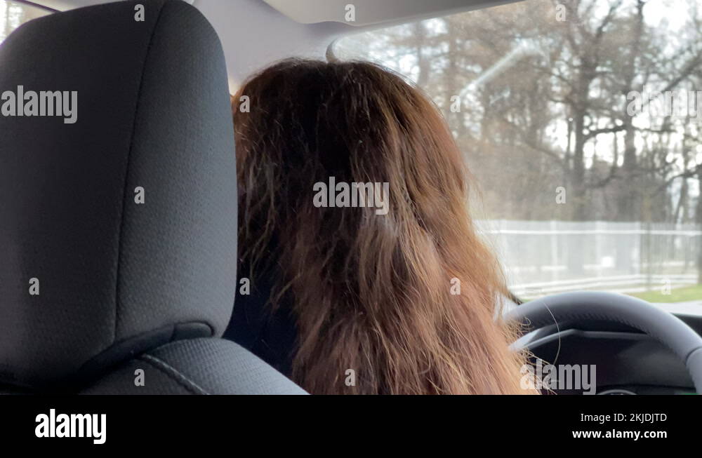 Female driver driving her car, woman behind the wheel Toyota RAV4 ...