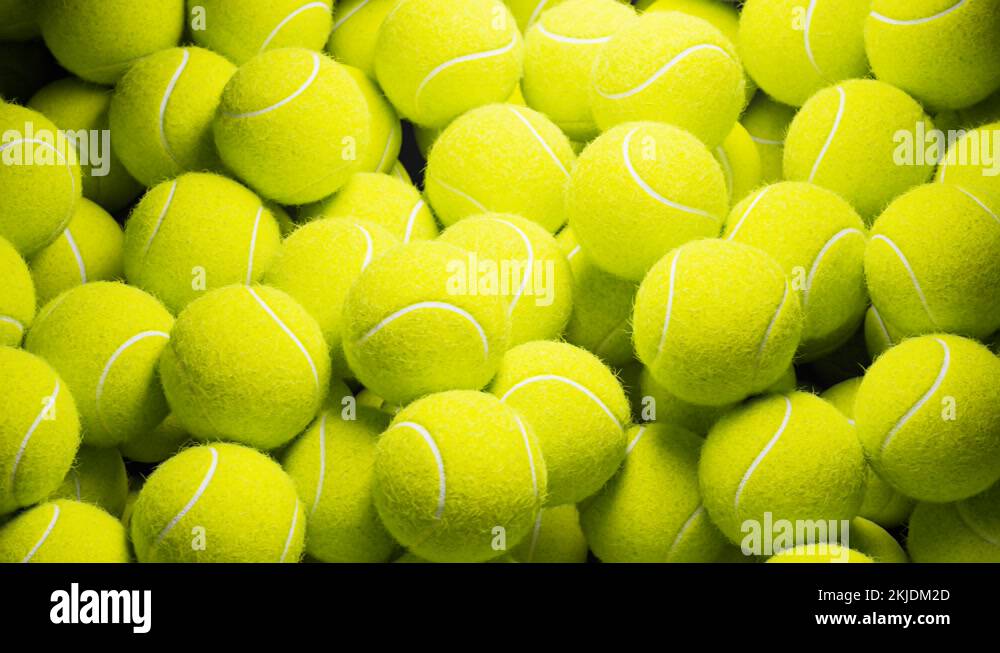 Seamless looping animation.Set of many tennis balls on the black ...
