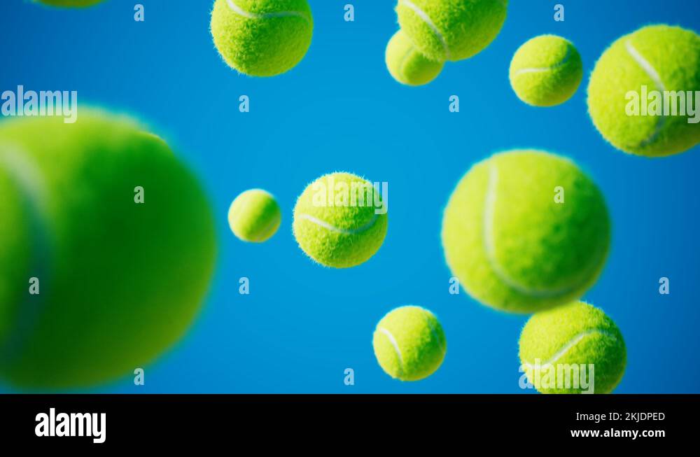 Loopable footage of falling tennis balls. Slow-motion. Blue background ...