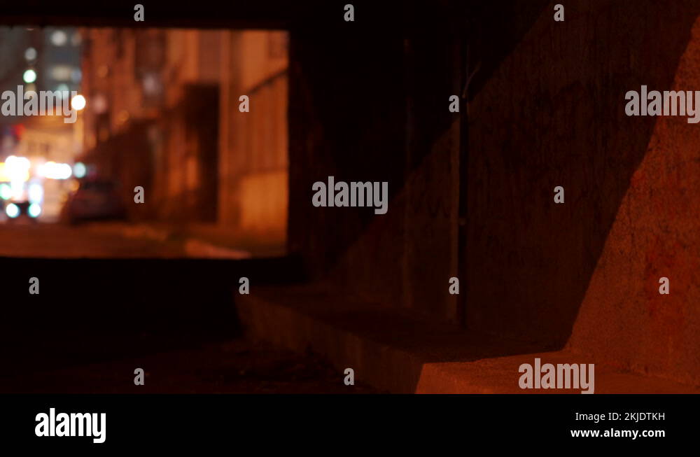 Dark stone gateway with glowing street light at the end of tunnel at ...