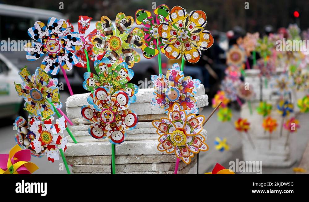 The Bustling Street Scene Of Hanoi, Vietnam, Pinwheels Toys, Moto, Cars ...