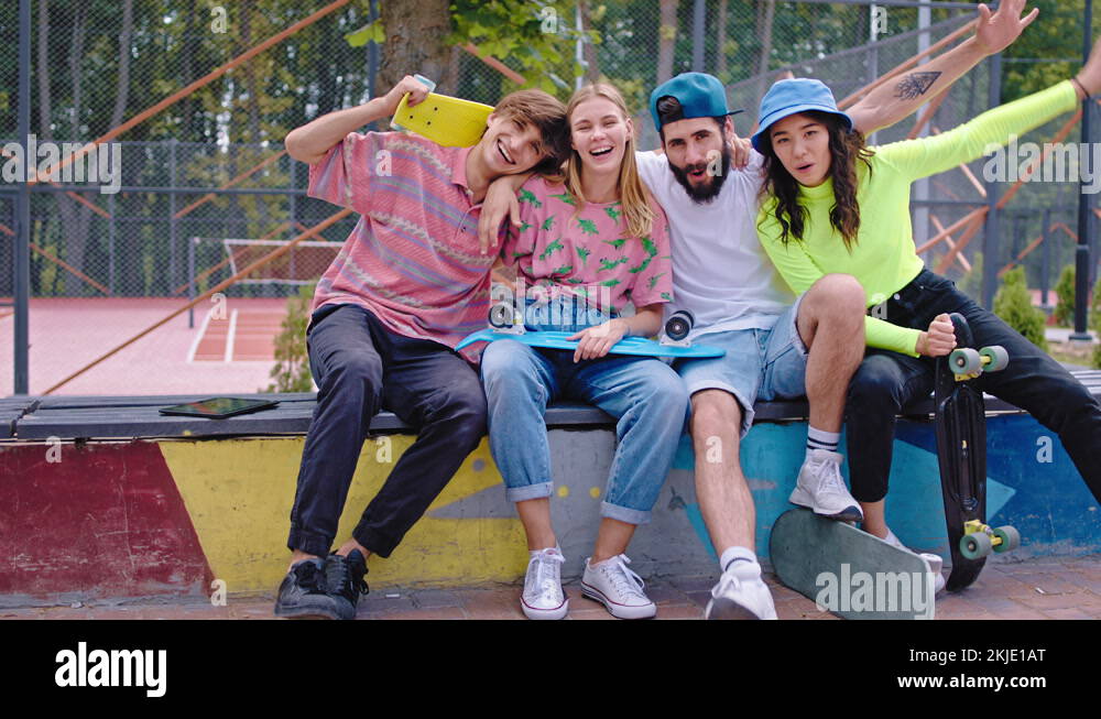 Sunny day in a modern skate park young group of friends multiethnic ...