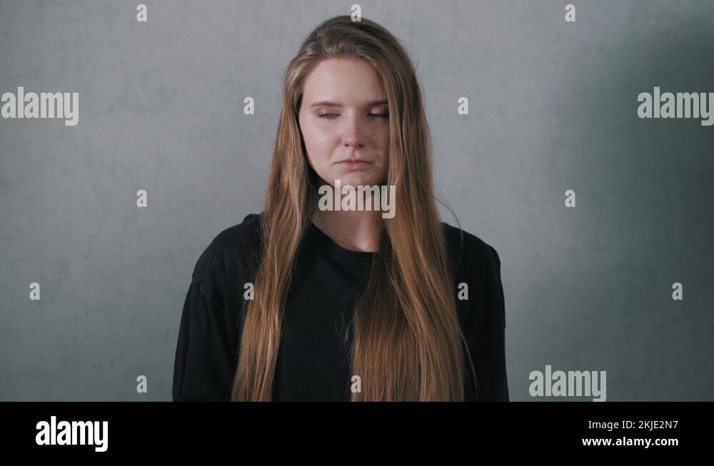 Young woman crying looking at the camera. Tears comes out of an eyes ...