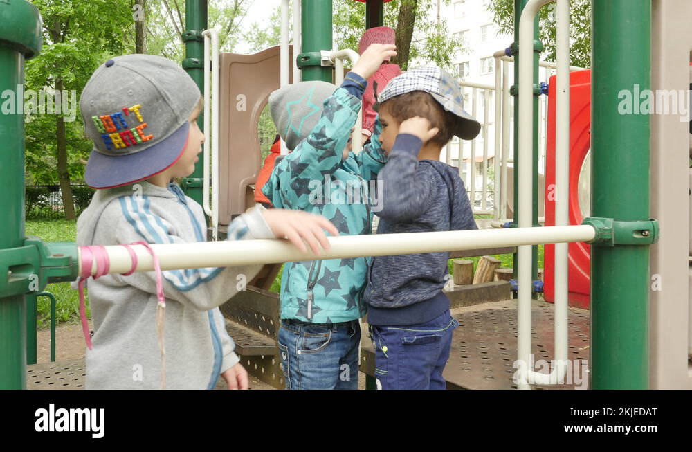 Children playing on playground. Group of boys and girls walking and ...