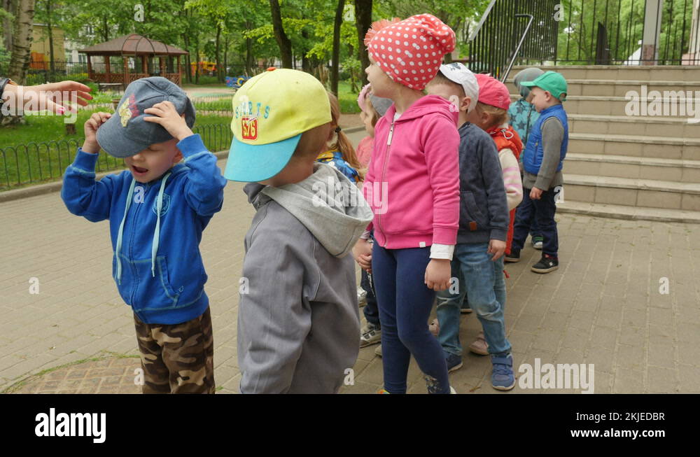 Kids on the walk. Group of children with nurse walk holding hands Stock ...