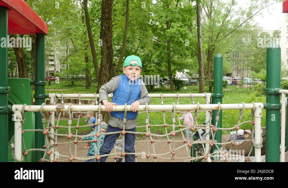 Girls and boys playing on playground. Group of kids walking at ...