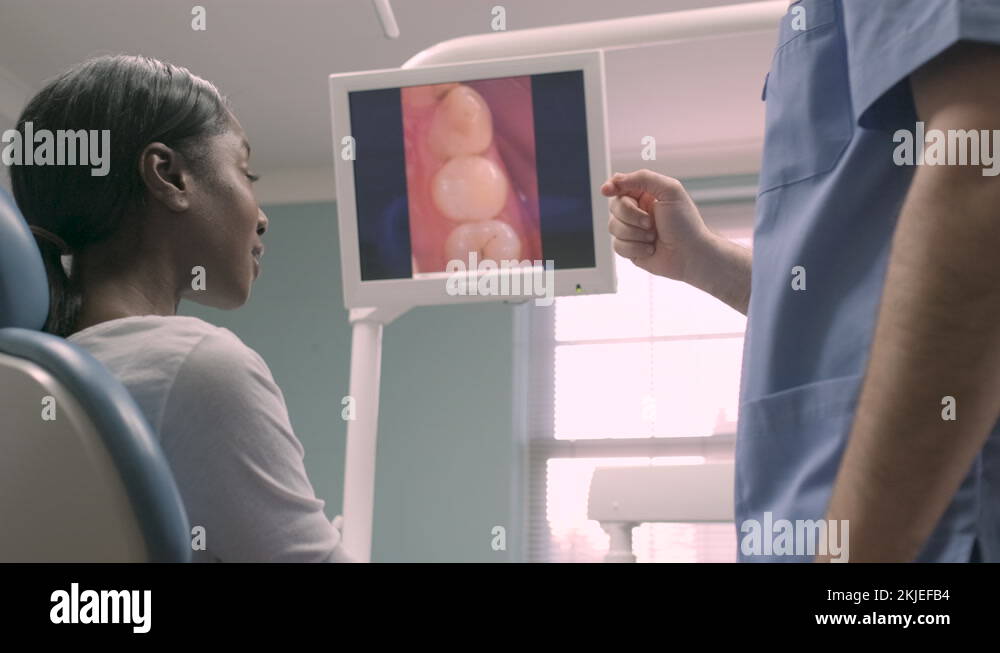 Dentist explaining treatment and showing on screen Stock Video Footage ...