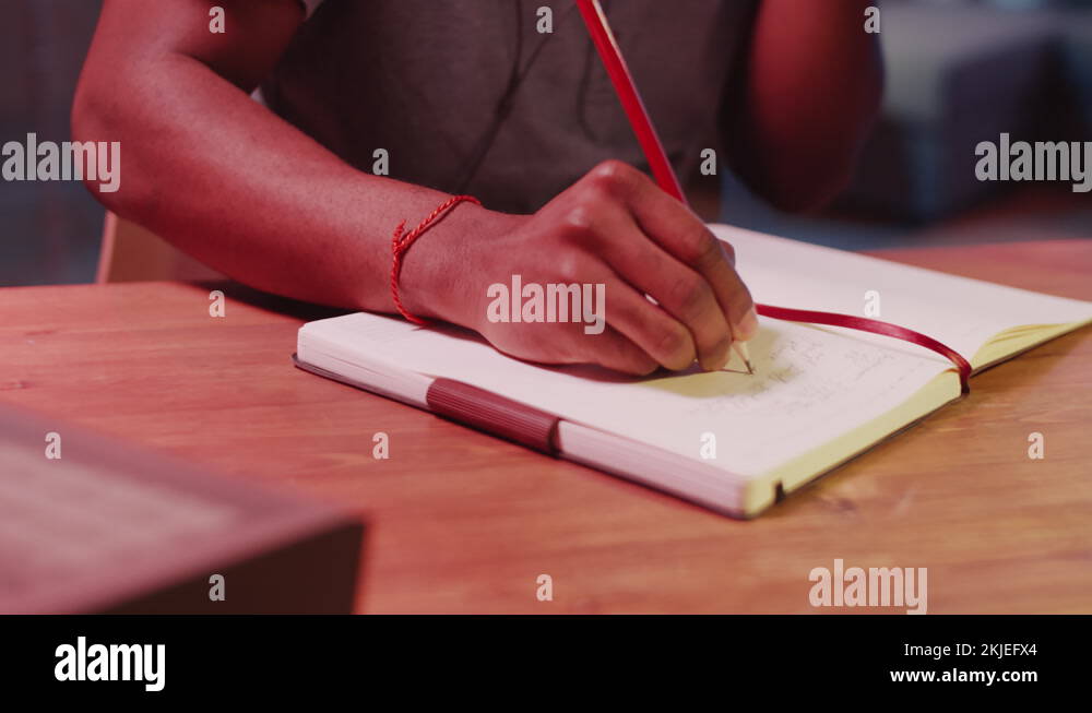Hands of Songwriter Writing Lyrics in Notepad in Home Recording Studio ...