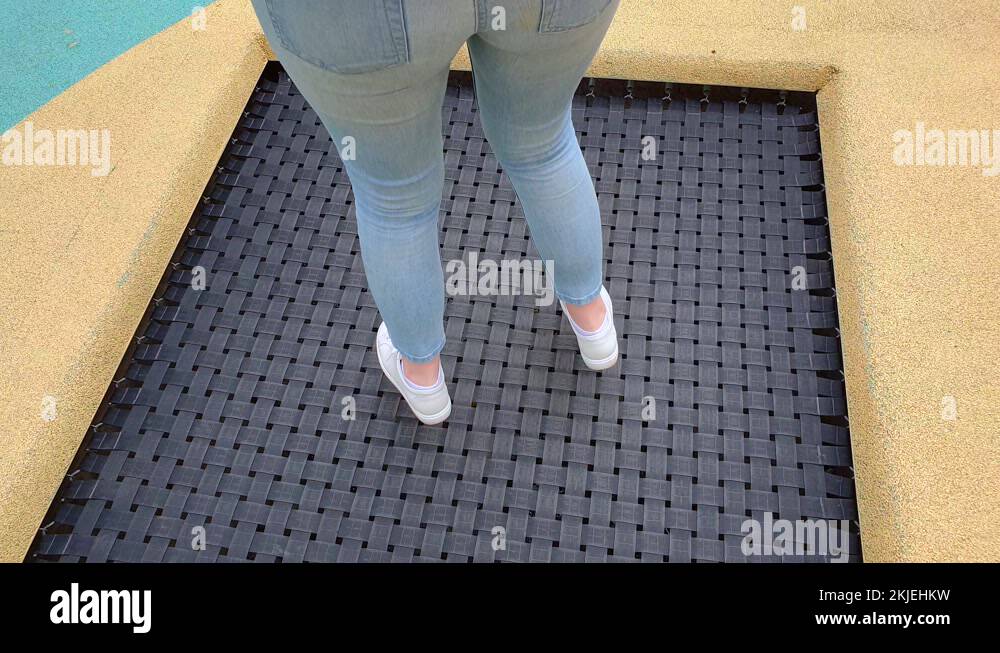 Trampoline jumping. Young woman happily jumping on a trampoline, top ...