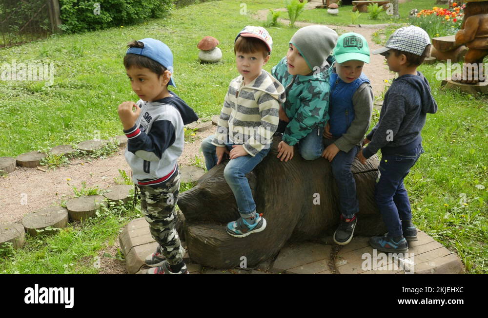 Children walk on kindergarten yard. Group of boys walking at ...
