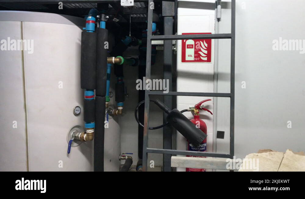 Engine room, large water tanks, pipelines and pumps for filtering water ...