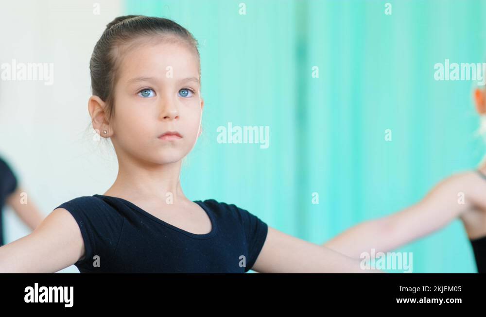 concentrated little girl with blue eyes practices ballet Stock Video ...