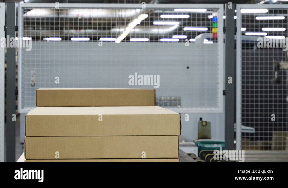 Furniture factory. Automated machine packaging furniture parts in boxes ...