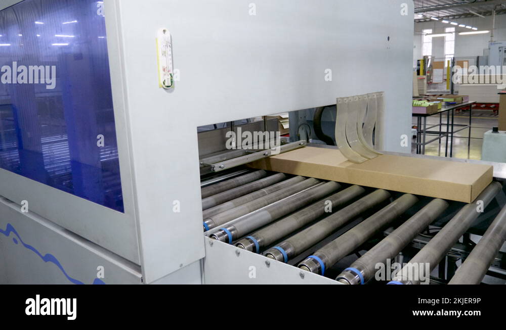 Furniture factory. Robotics packaging parts of furniture in cardboard ...