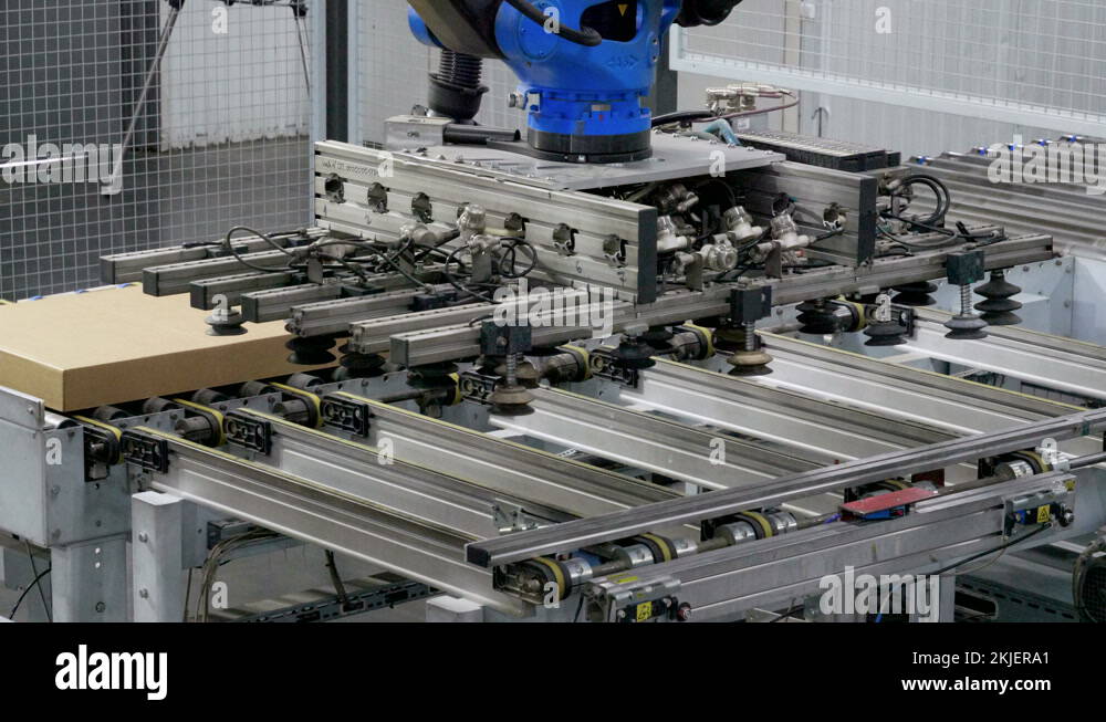 Furniture factory. Furniture parts are packaged on automated packaging ...