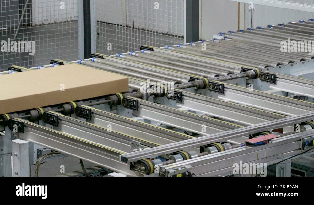 Furniture factory. Furniture parts are packaged on automated packaging ...