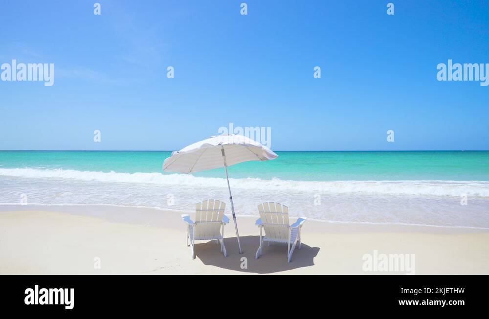 Beach chairs behind sea beach. Beautiful parasol evolving in the wind ...