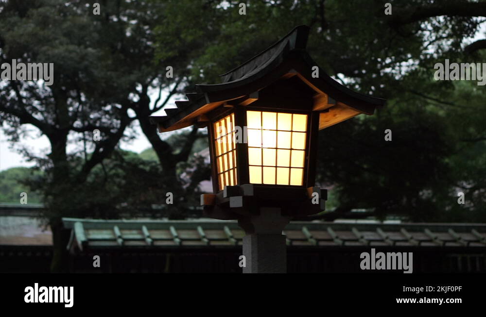 Japanese classic style wooden lamp pole with roof in shrine illuminated ...
