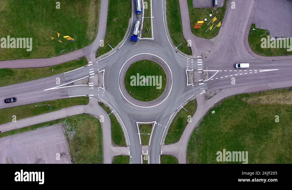 Top-down view over traffic intersection with roads and a roundabout ...