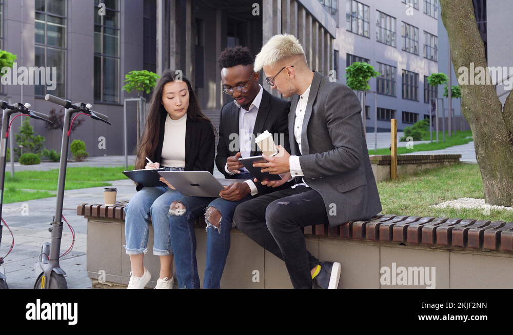 Attractive high -skilled diverse creative team of two guys and one girl ...