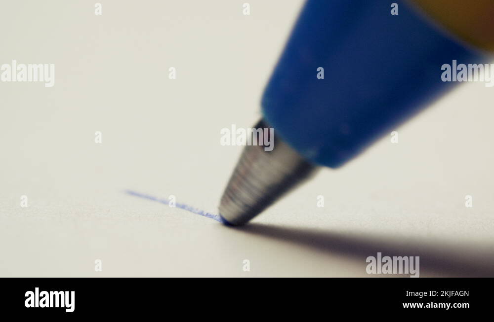 Pen draws a check mark on a white background paper, macro shot Stock ...
