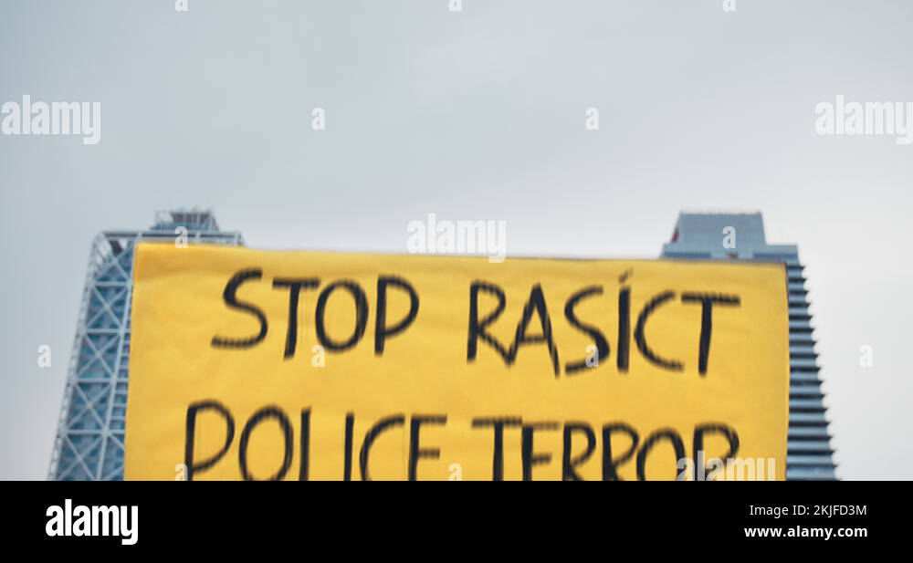 Man holding up stop rasict poster in the hands at demonstration. Stop ...
